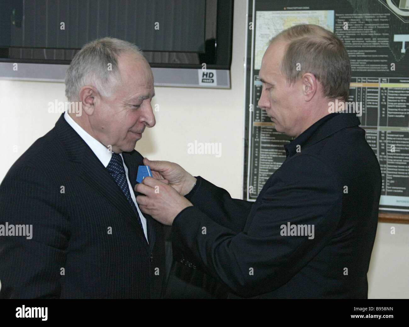 Russian President Vladimir Putin right conferring the Order of Honor on ...