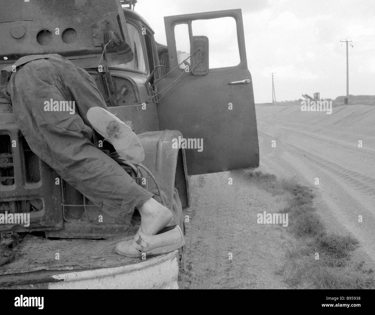 A driver fixing his car Stock Photo - Alamy