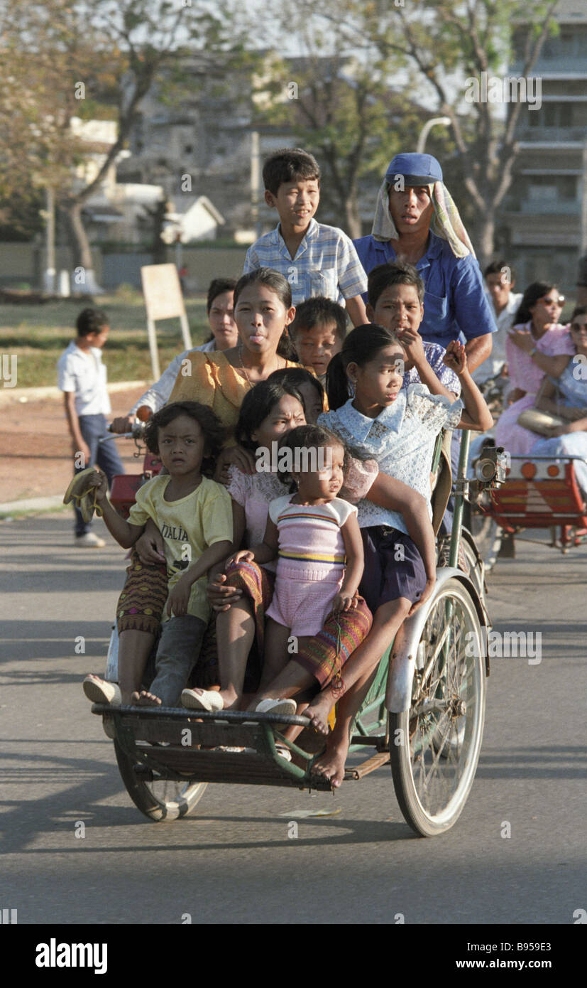 Family driving in a rickshaw Stock Photo - Alamy