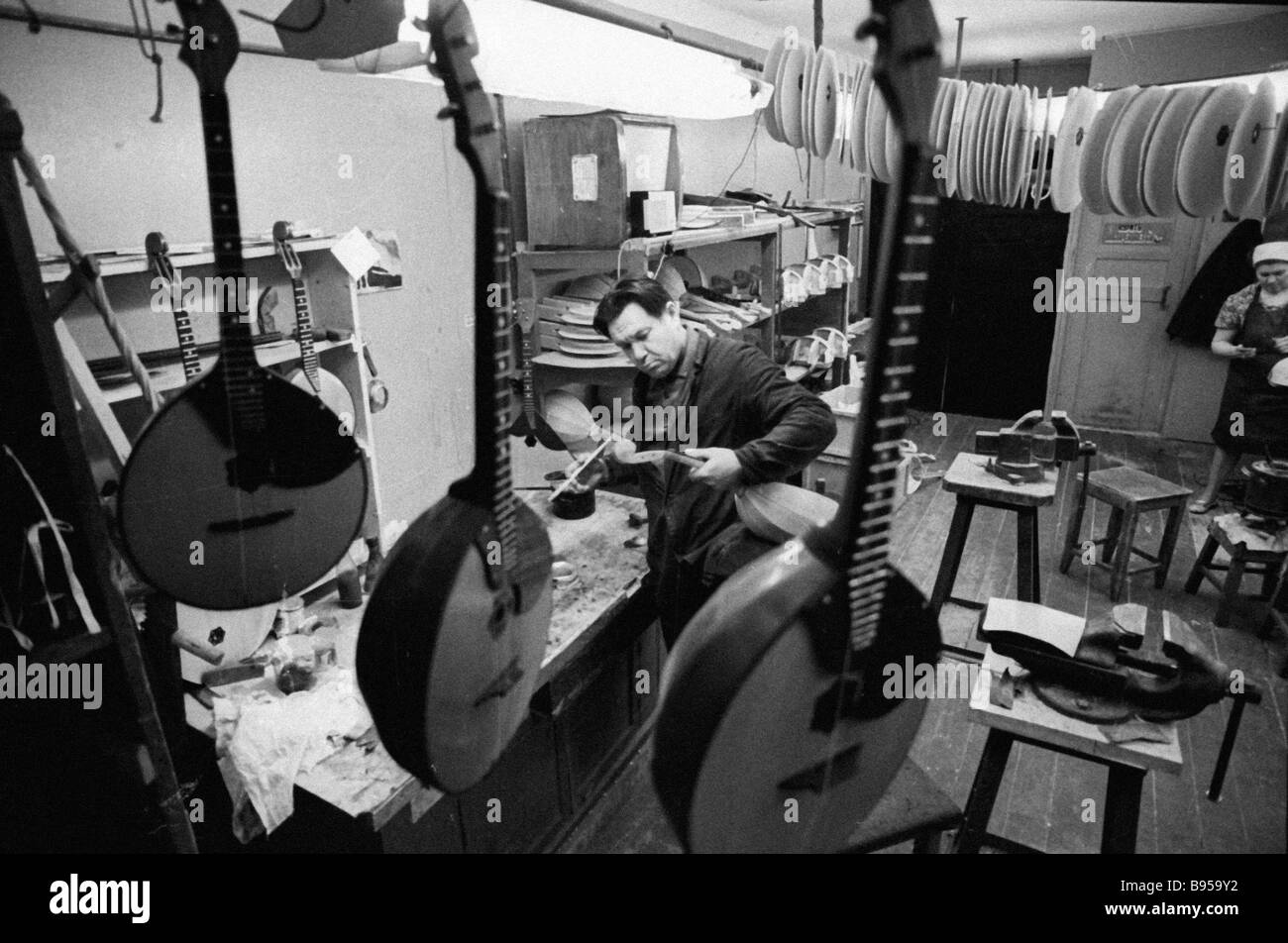 A worker at the Moscow experimental musical instruments factory making ...