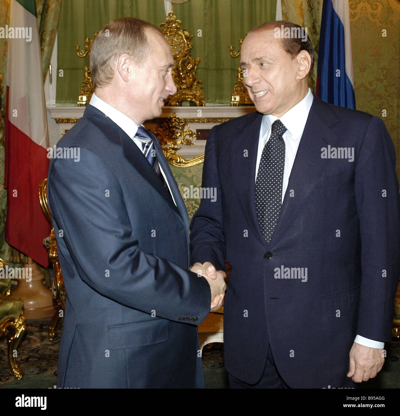 Russian President Vladimir Putin left and Italian Prime Minister Silvio ...
