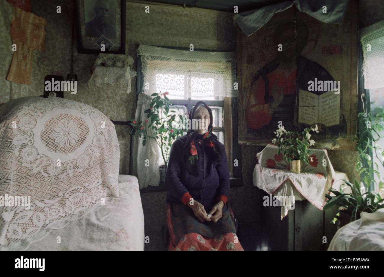 An elderly villager sitting at the window Stock Photo - Alamy