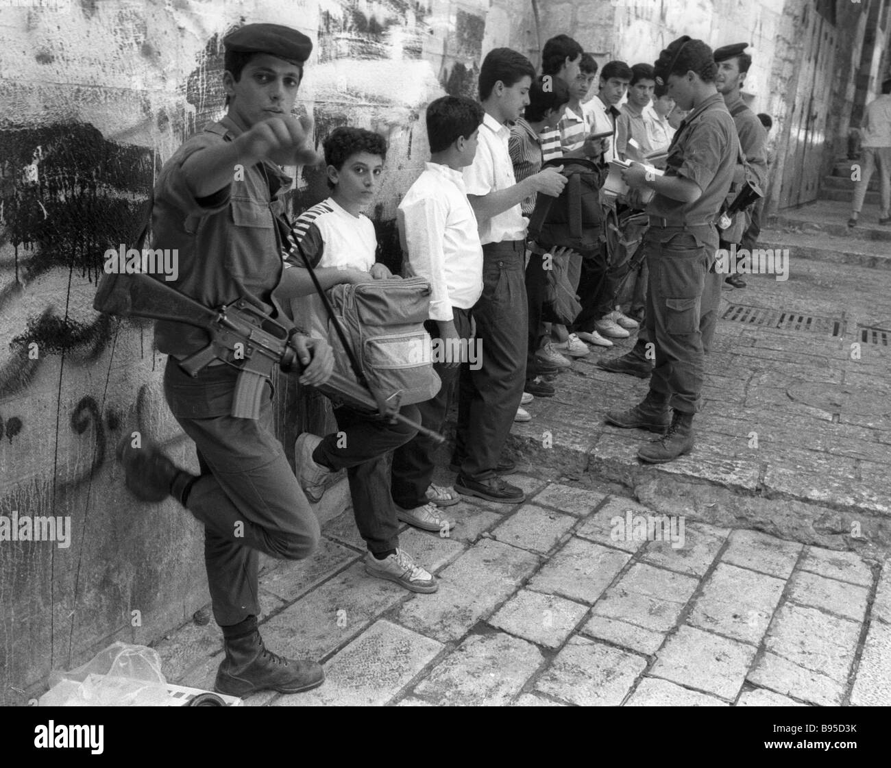 Israeli soldiers check IDs of Palestinian schoolchildren Stock Photo ...