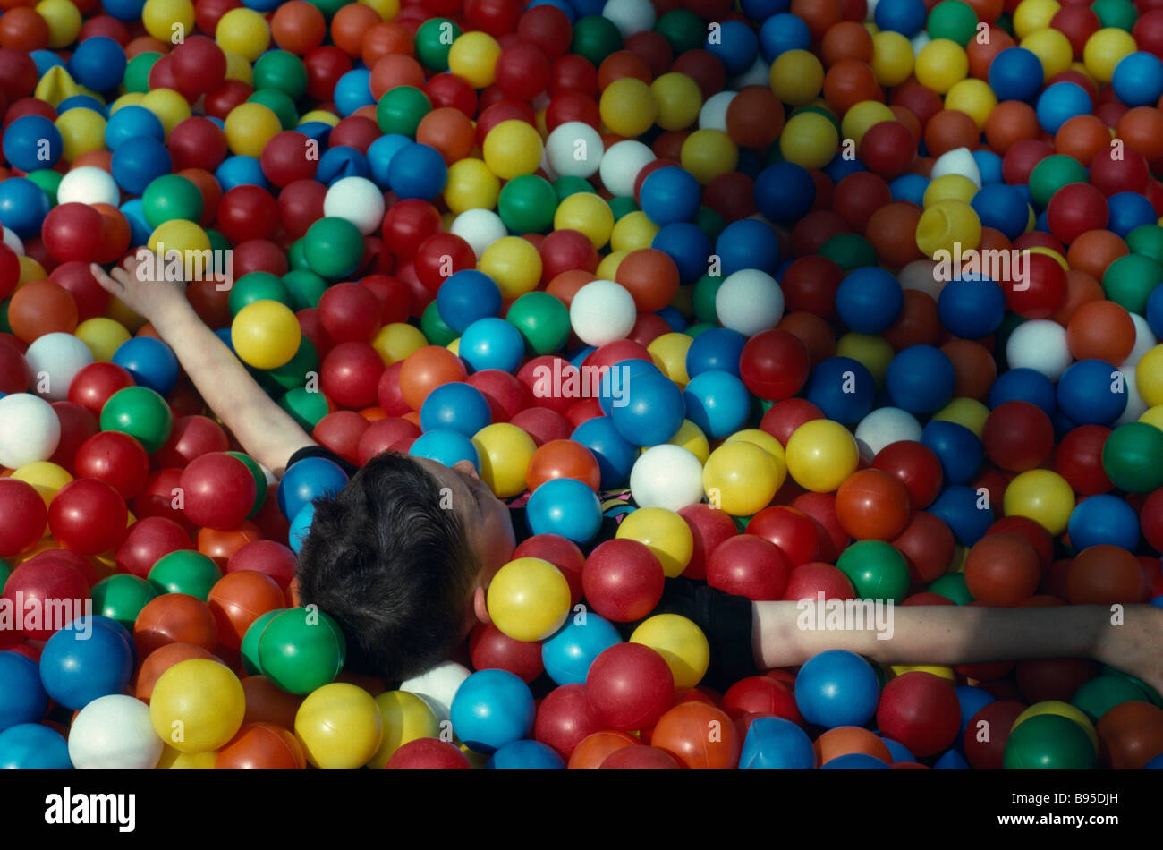 CHILDREN Play Child playing in multi coloured fun balls Stock Photo - Alamy