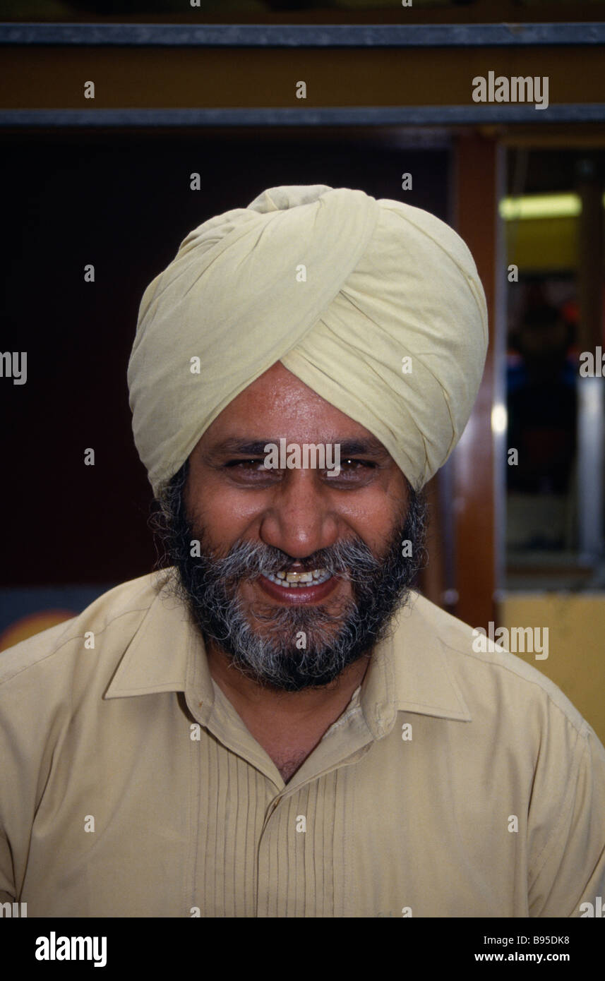 ENGLAND London Head and shoulders portrait of a Sikh man smiling ...