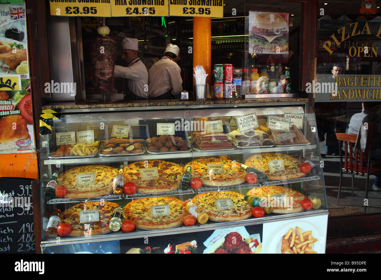 A takeaway shop sells kebabs and pizzas and other junk food Stock Photo ...