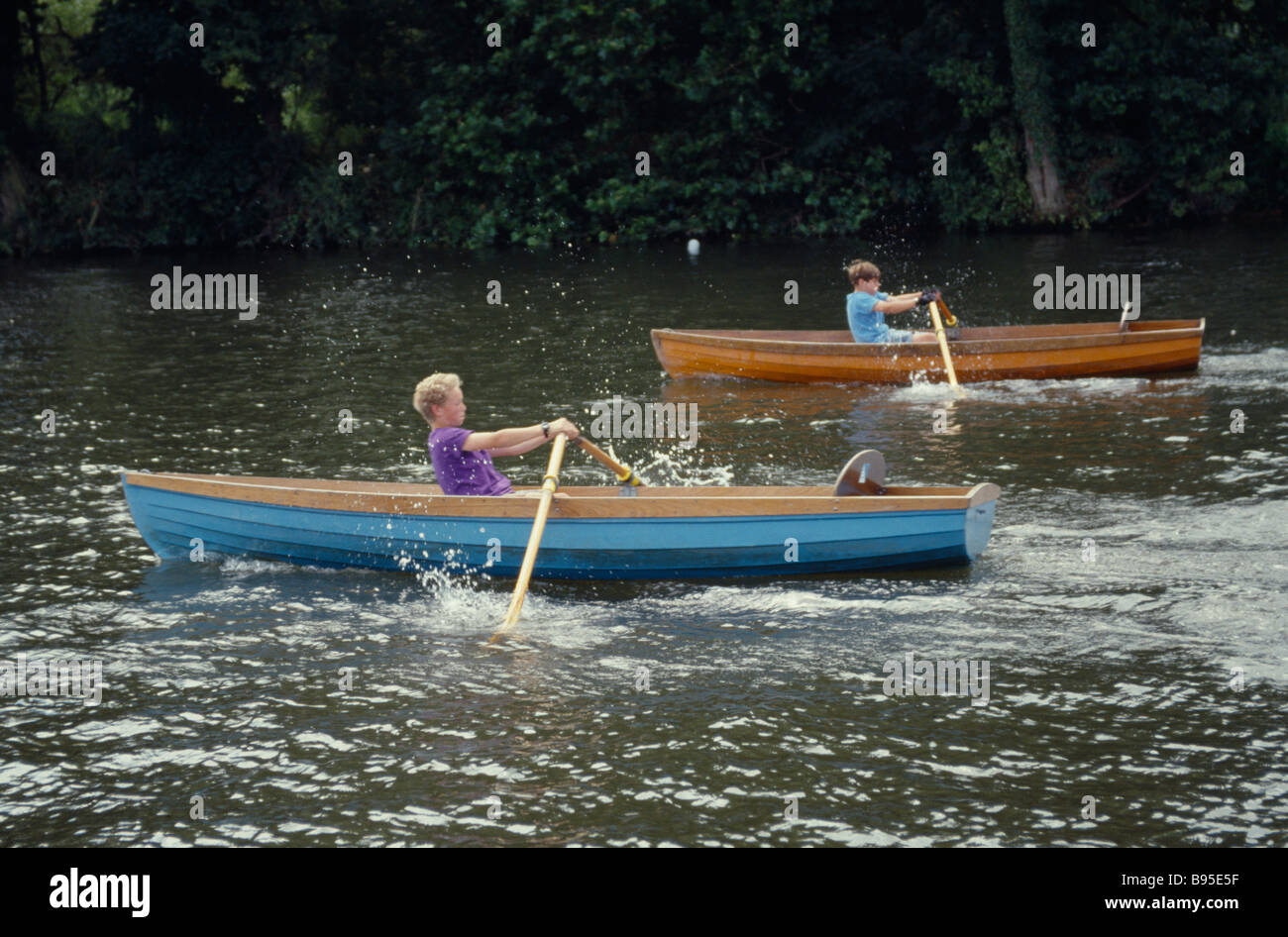 SPORT Water Sport Rowing Two boys in wooden boats competing in rowing ...
