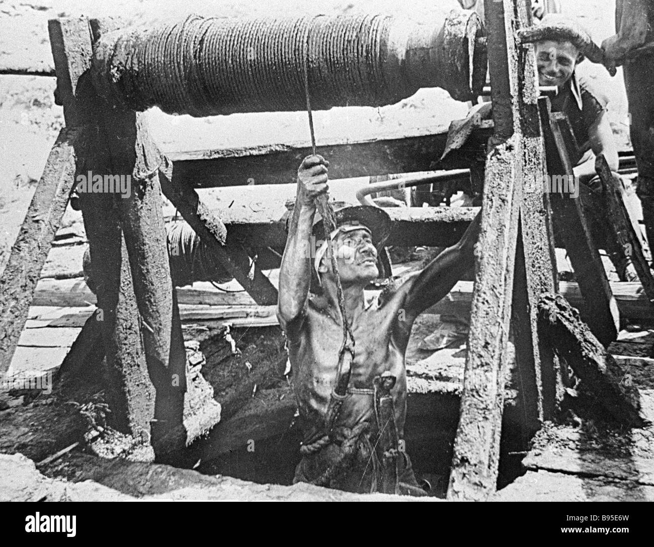 A miner in a mud oil producing mine Stock Photo - Alamy