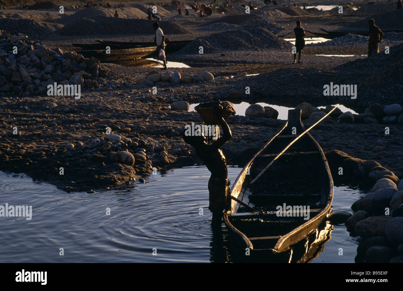 BANGLADESH Jafflong Workers in stone quarry near water with man in ...