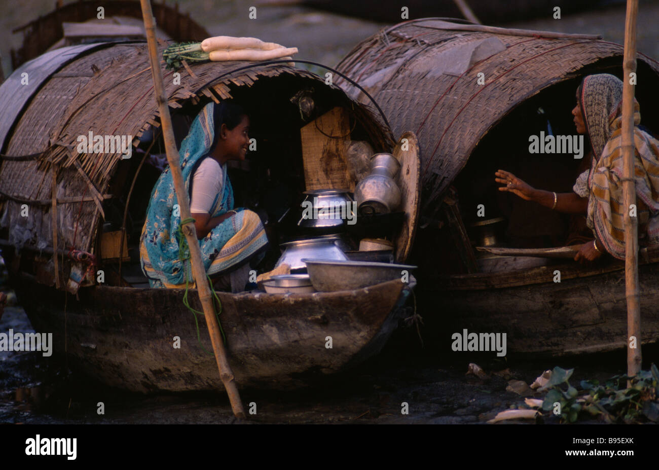 BANGLADESH Transport Two female river gypsies in covered wooden boats ...
