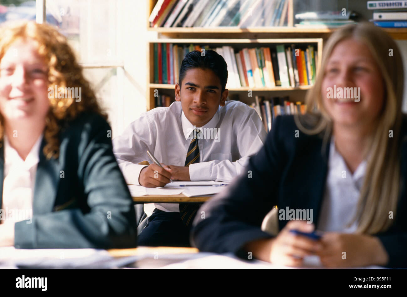 EDUCATION Secondary School Male and female pupils smiling working at ...