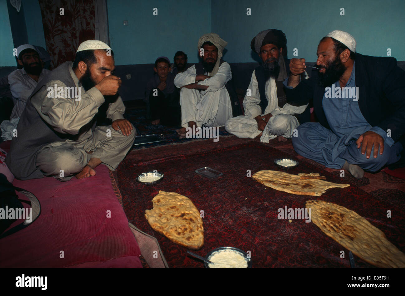 AFGHANISTAN Kabul Pashtun men eating traditional meal of bread and ...