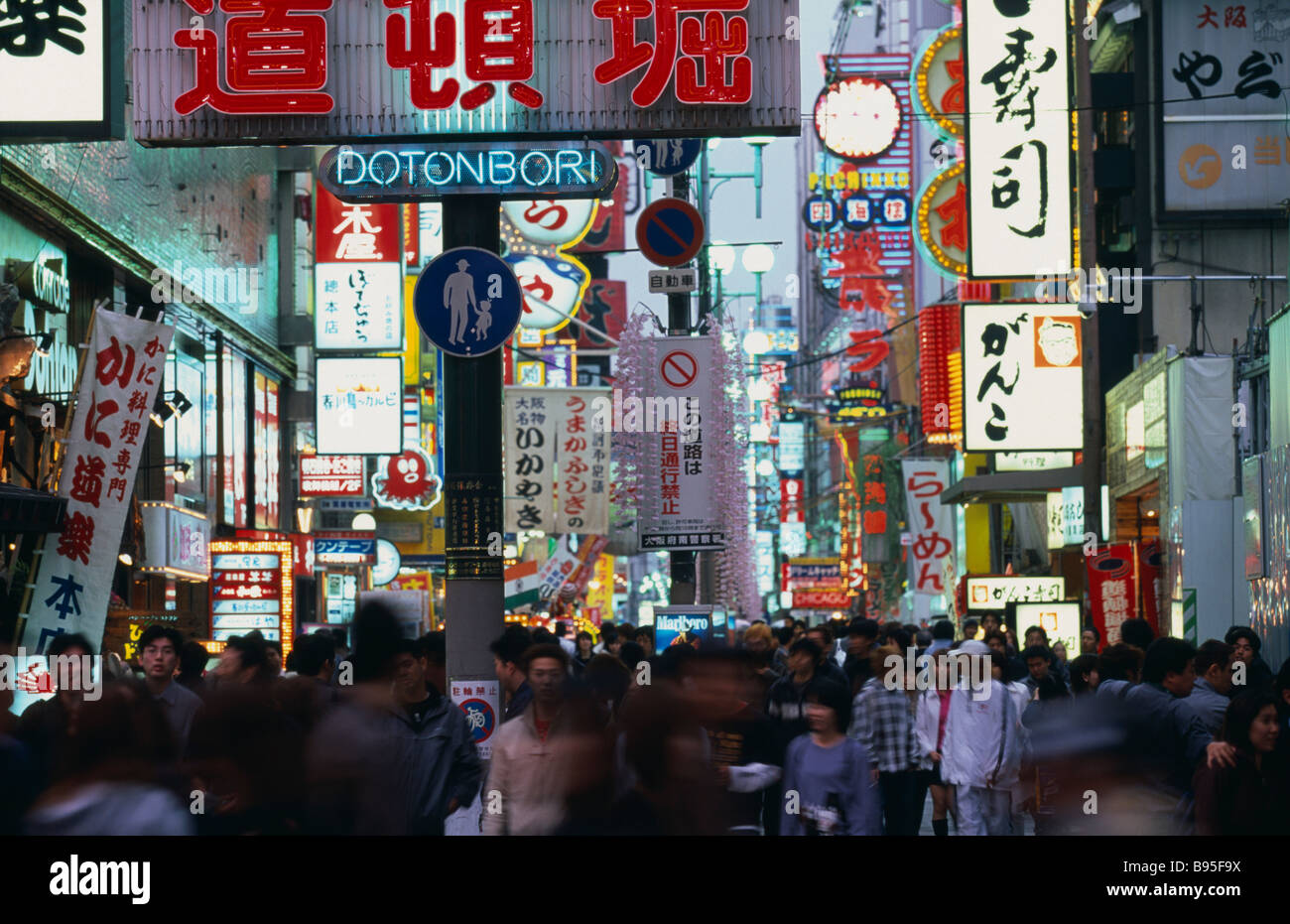 JAPAN Honshu Osaka Dotonbori sign illuminated at dusk among mass of ...