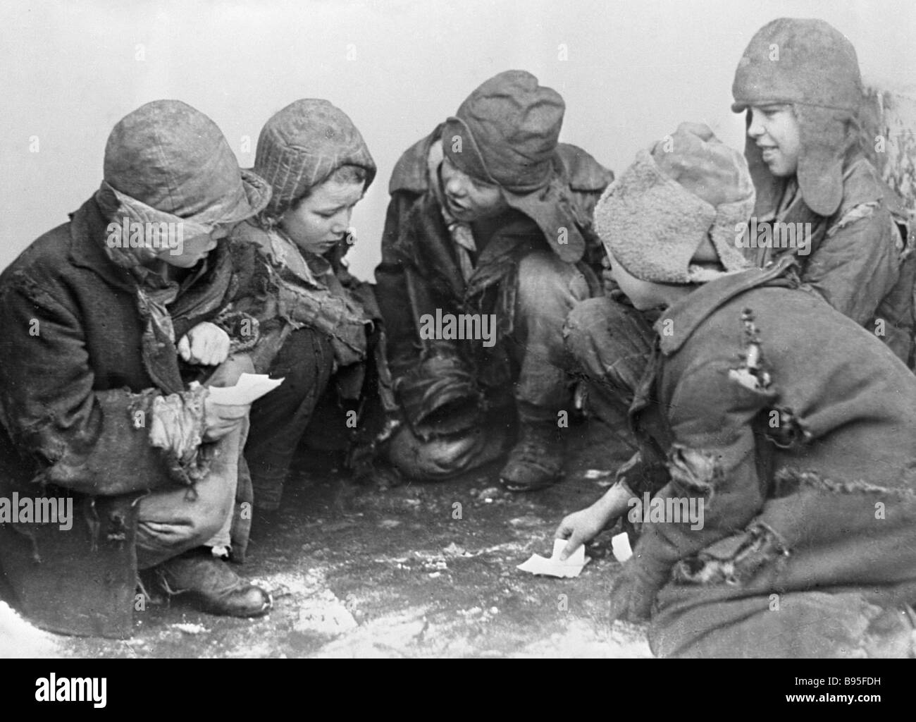 Homeless boys playing cards in the street Stock Photo - Alamy