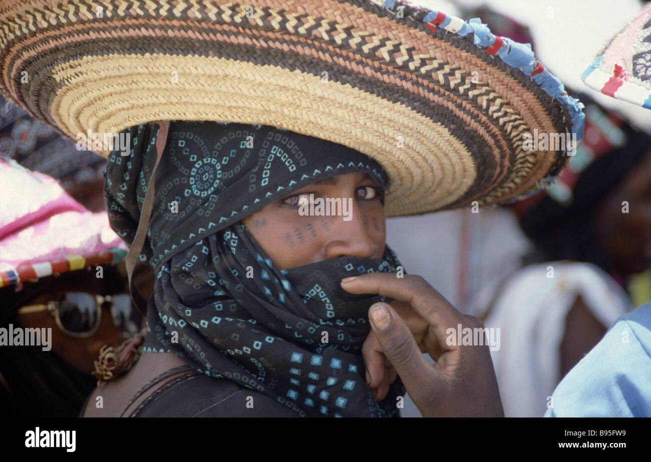 NIGERIA West Africa Wodaabe man wearing wide brimmed hat and scarf over ...