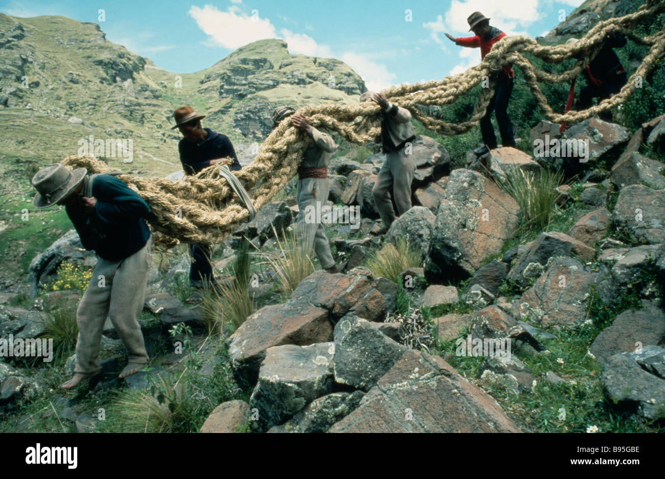 PERU Apurimac River Gorge Chumbivilcas Hills men carrying thick grass ...