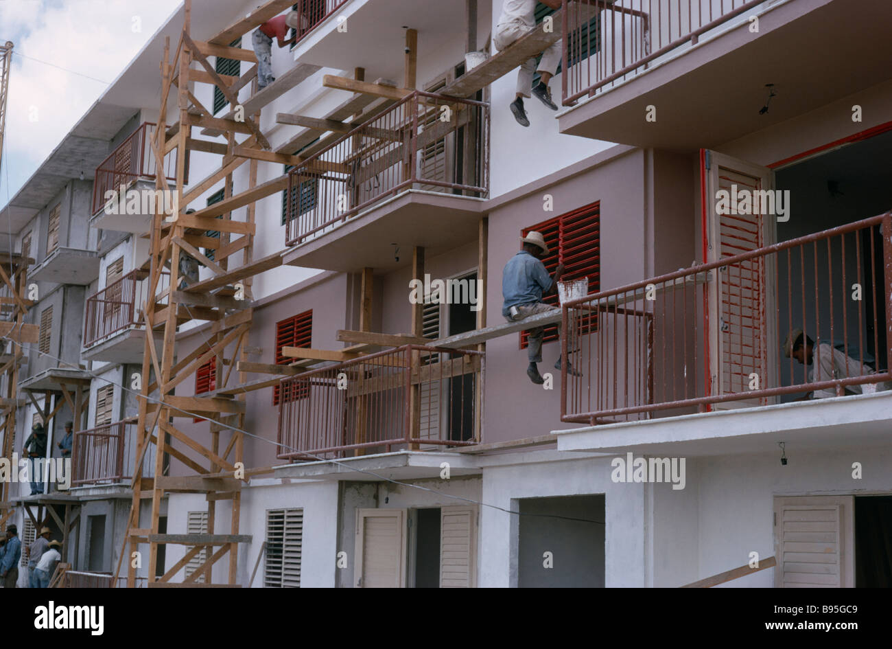 CUBA Industry Construction workers and painters on wooden scaffolding ...