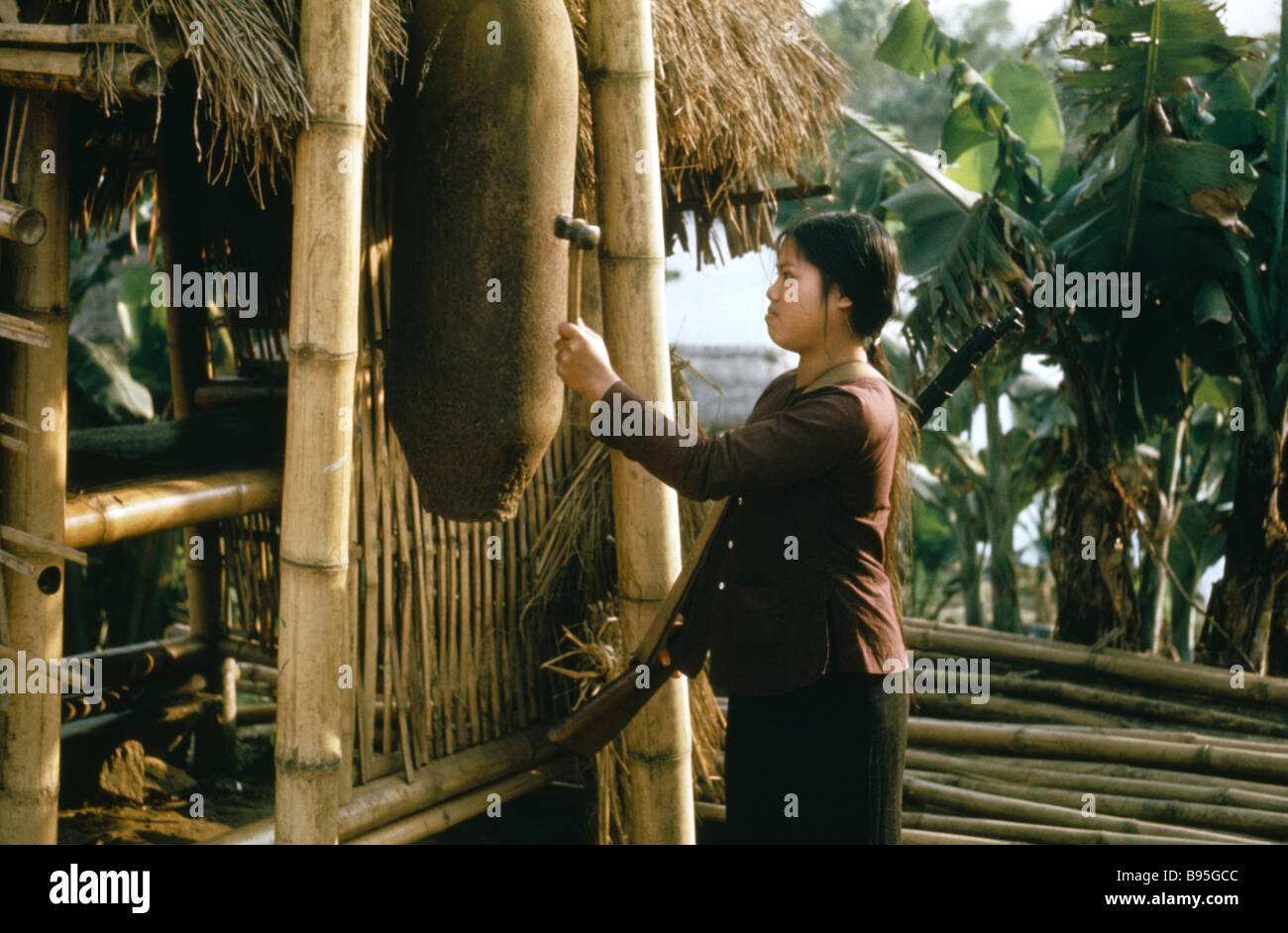 VIETNAM War North Central Young woman using American bomb casing as an ...
