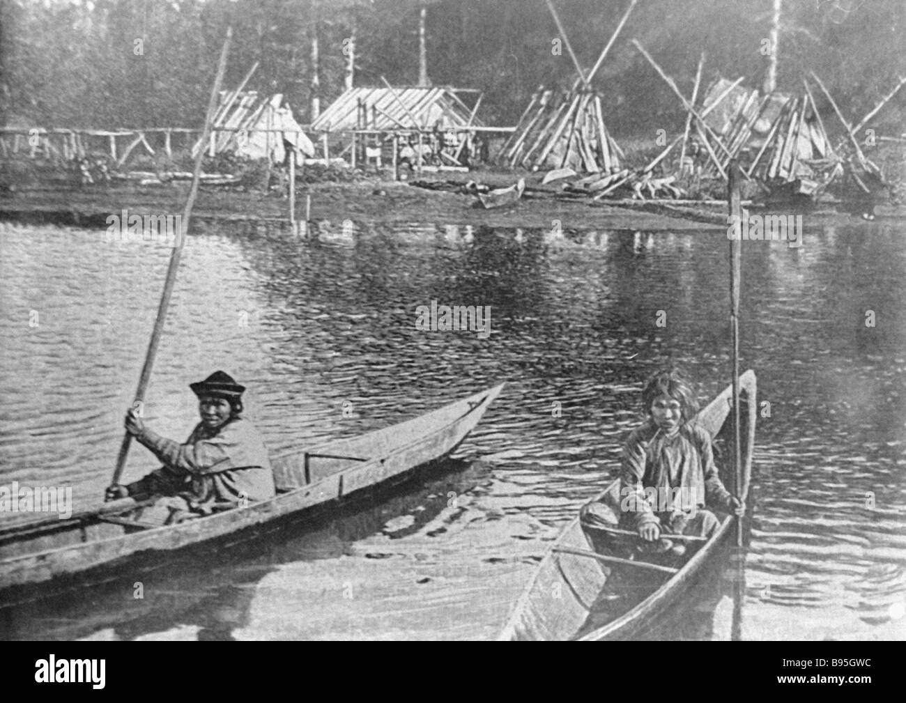 Udege nationals in boats against backdrop of Udege nomad camp 19th 20th ...