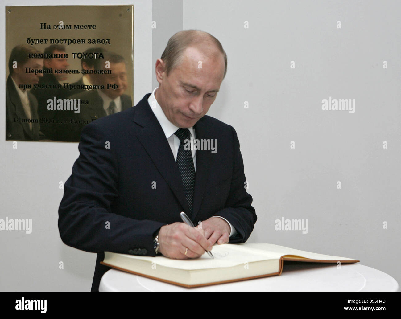Russian President Vladimir Putin signing the book of distinguished ...