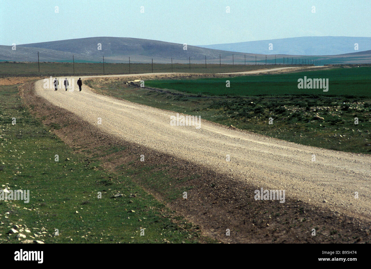 turkish farmers walking home along an Anatolian steppe road Turkey ...