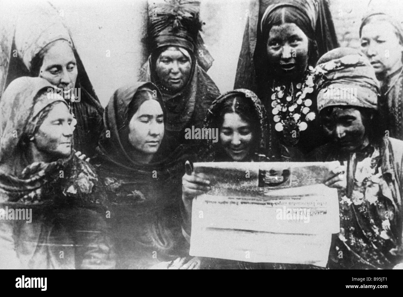 Turkmen women reading paper Stock Photo - Alamy