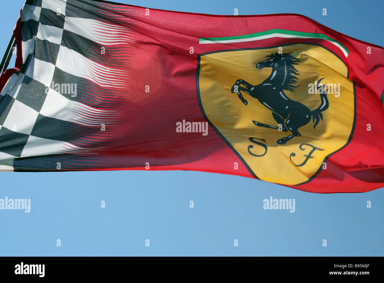 The Ferrari flag flying in the wind Stock Photo - Alamy