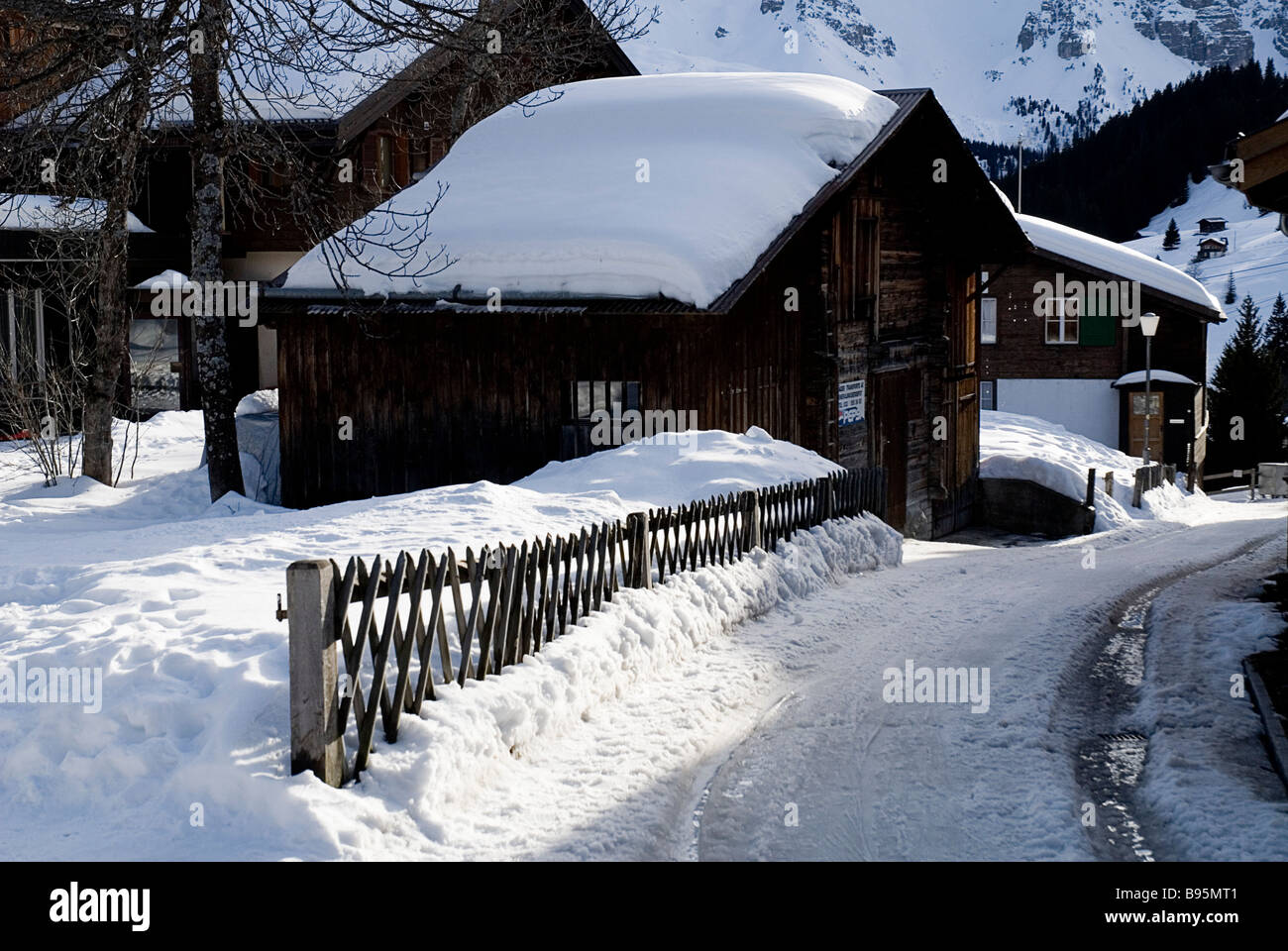 Switzerland, Bernese Oberland, Murren. Snow covered chalet housing ...