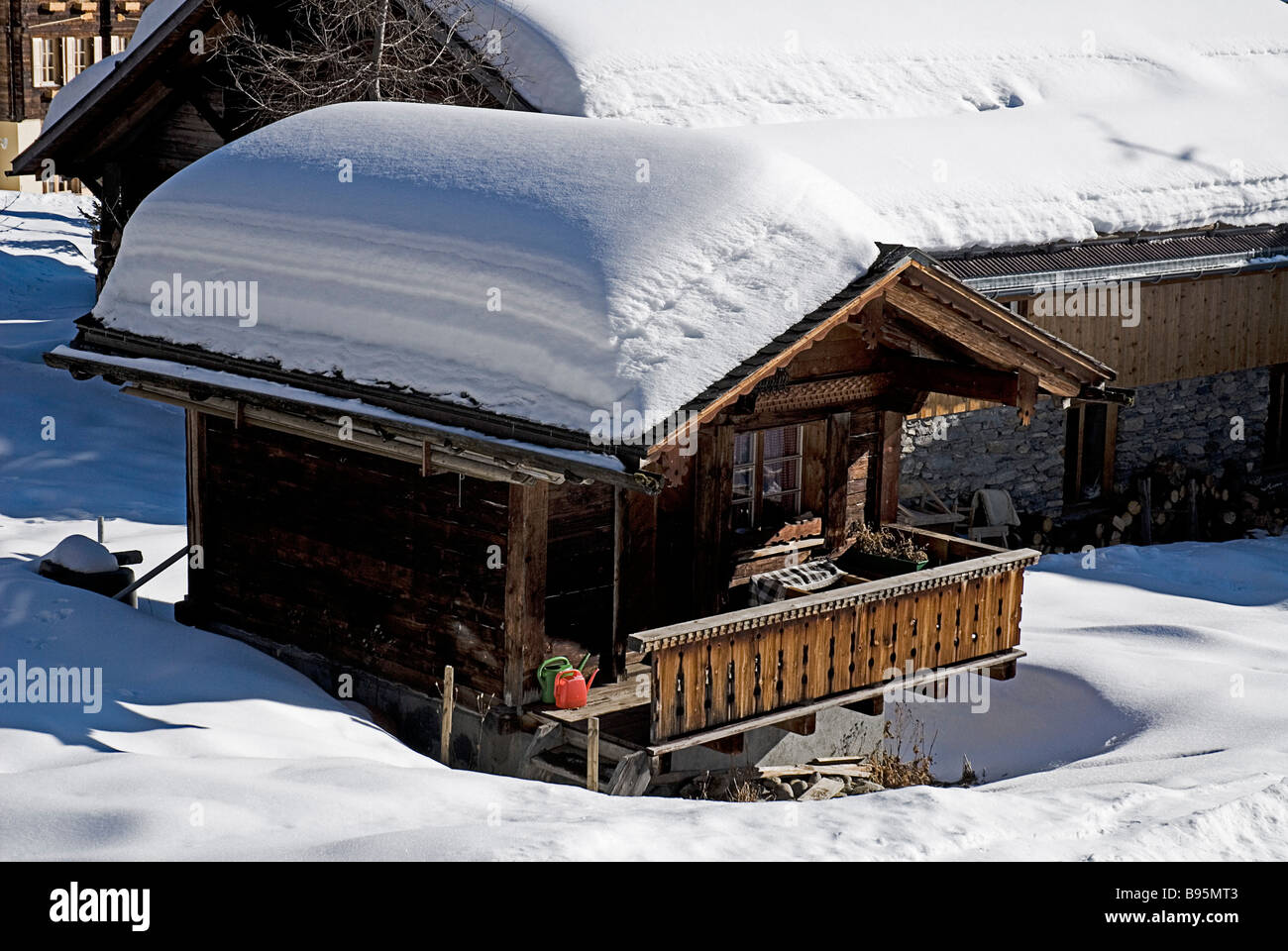 Switzerland, Bernese Oberland, Murren. Snow covered chalet housing in ...