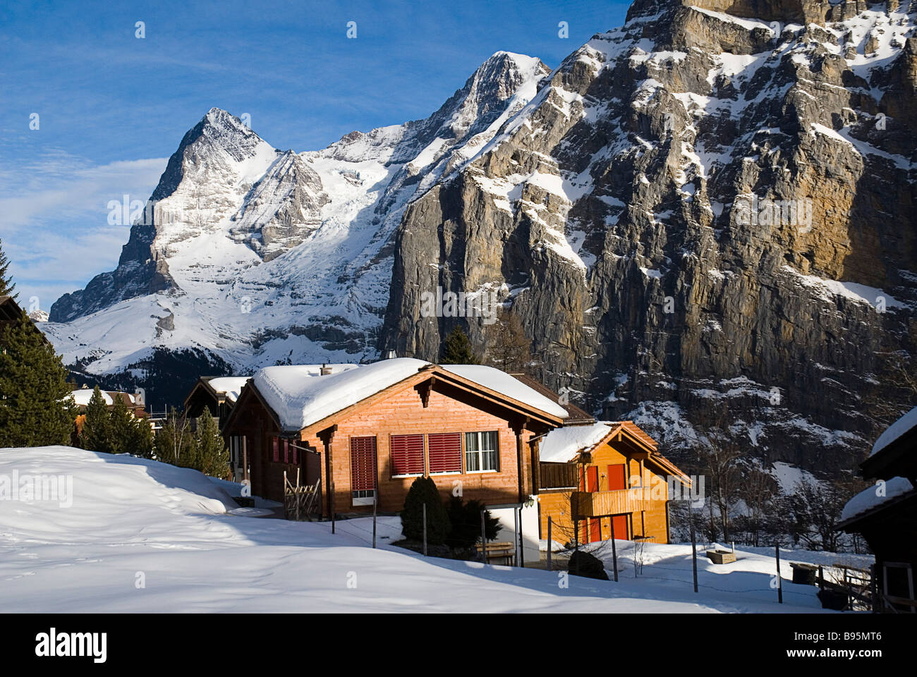 Switzerland, Bernese Oberland, Murren. Snow covered chalet houses in ...