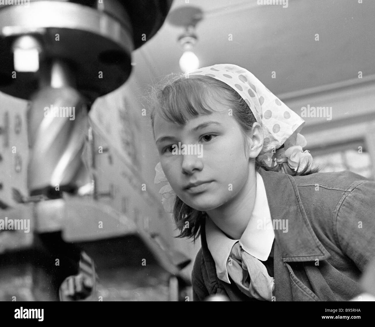 A girl studying a fitter s lathe at a handwork lesson Stock Photo - Alamy