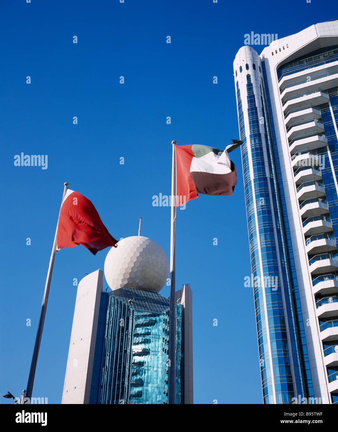 UAE Dubai Deira Etisalat Building on Dubai Creek with flag poles in ...