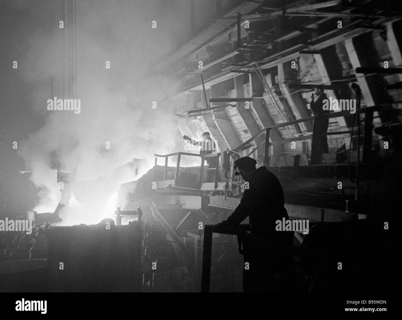 A steelmaker controlling hot metal flow in a blast furnace hearth Stock ...