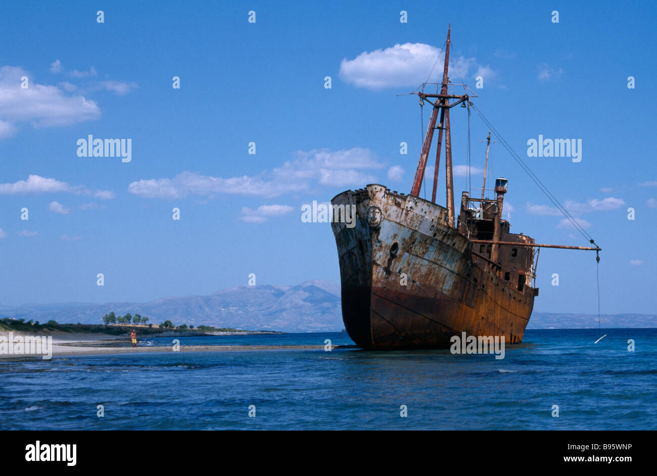 GREECE Peloponnese Rusty shipwreck beached in shallow water next to ...
