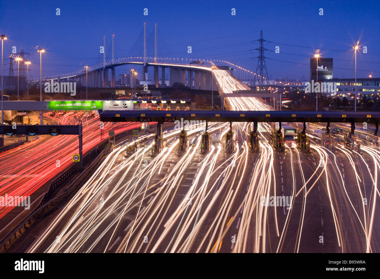 Traffic passing through toll booths at night. Queen Elizabeth II Bridge ...