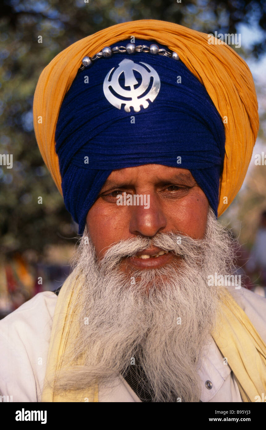 INDIA South Asia Delhi Portrait of a sikh man wearing orange and royal ...
