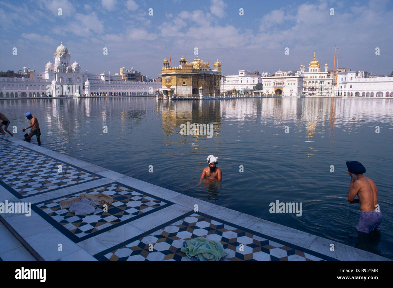 INDIA Punjab Amritsar Sikh Golden Temple Men bathing in the sacred pool ...