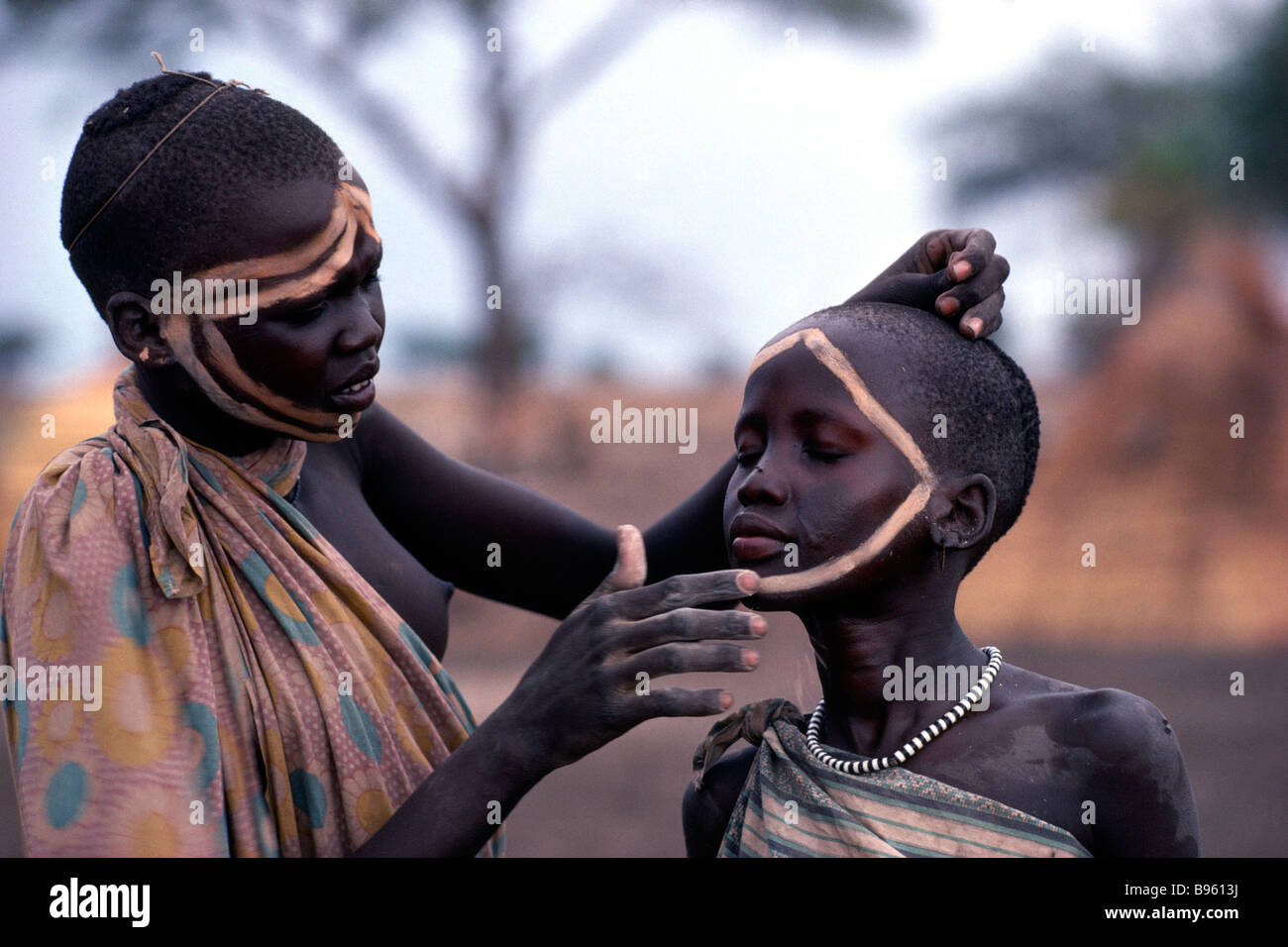 SUDAN Horn of Africa Tribal People Dinka girl decorating the face of ...