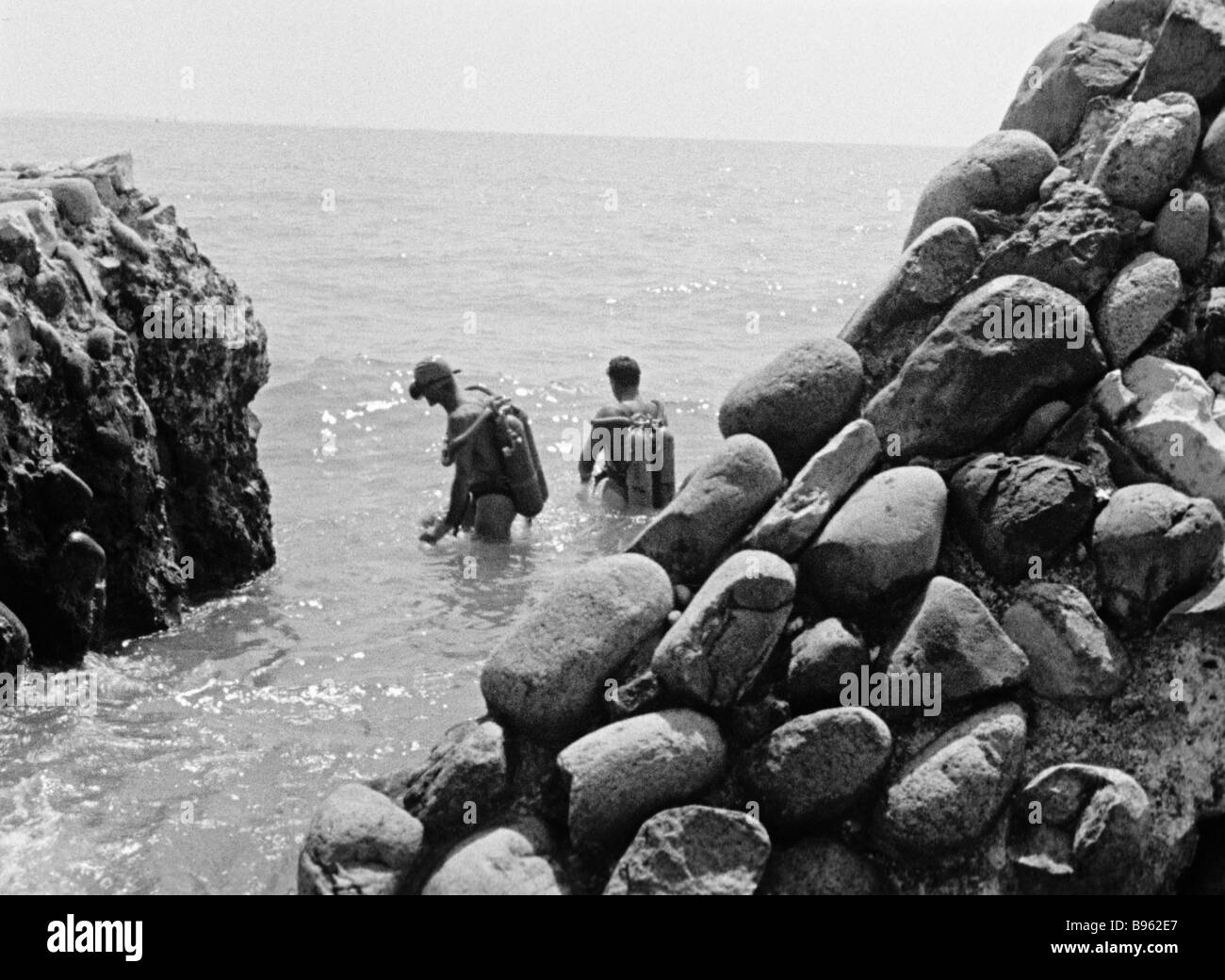 Archaeologists in scuba outfits entering the sea to carry out ...