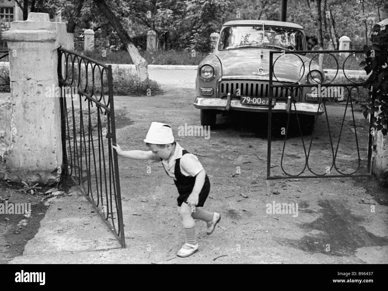 A child opening the gate for a car Stock Photo - Alamy