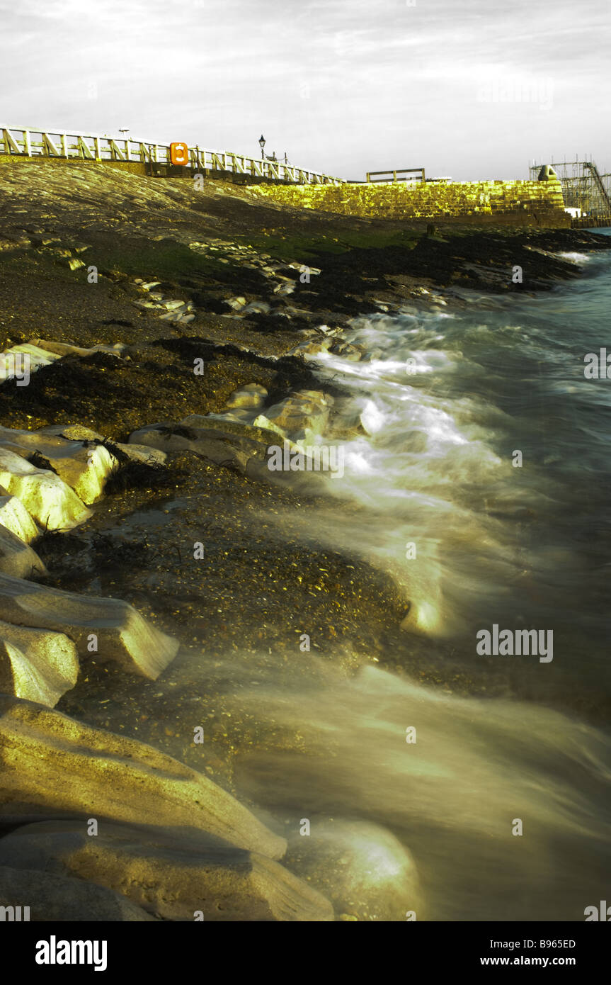 Long exposure of waves lapping against the shoreline, misty effect ...
