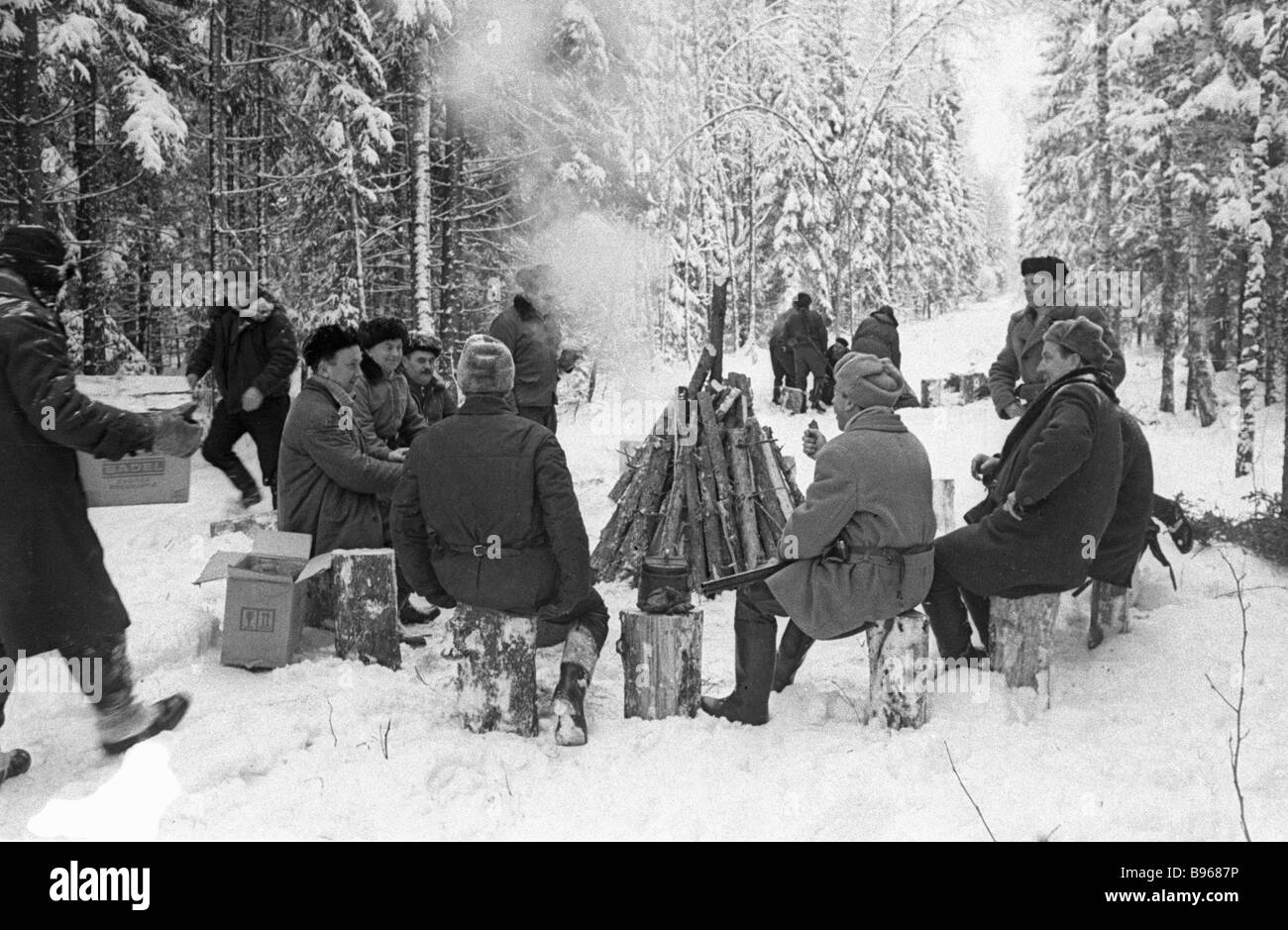 Hunters light bonfire in a forest Stock Photo - Alamy