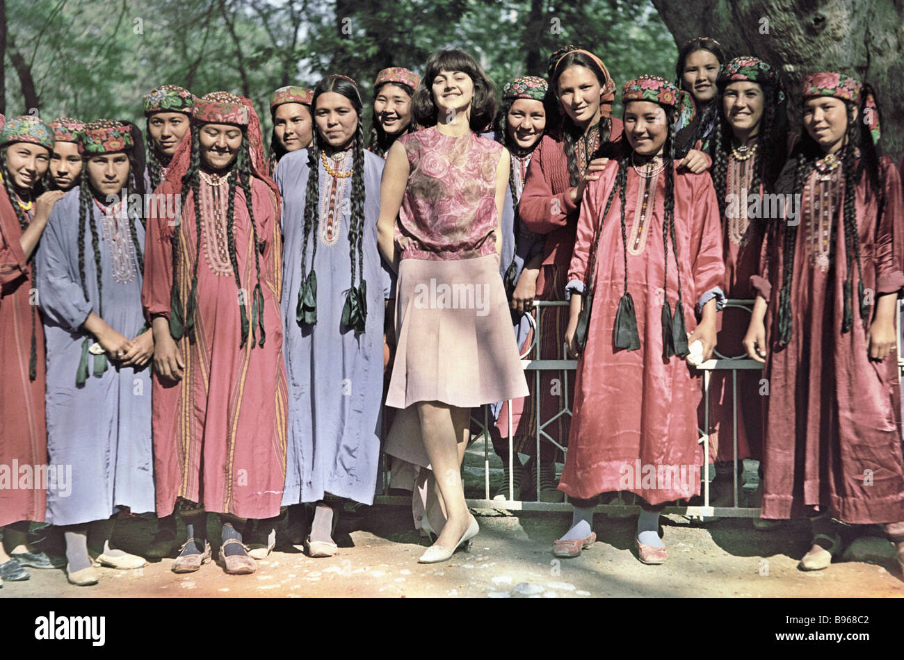 A city resident with villagers in traditional dress Stock Photo - Alamy