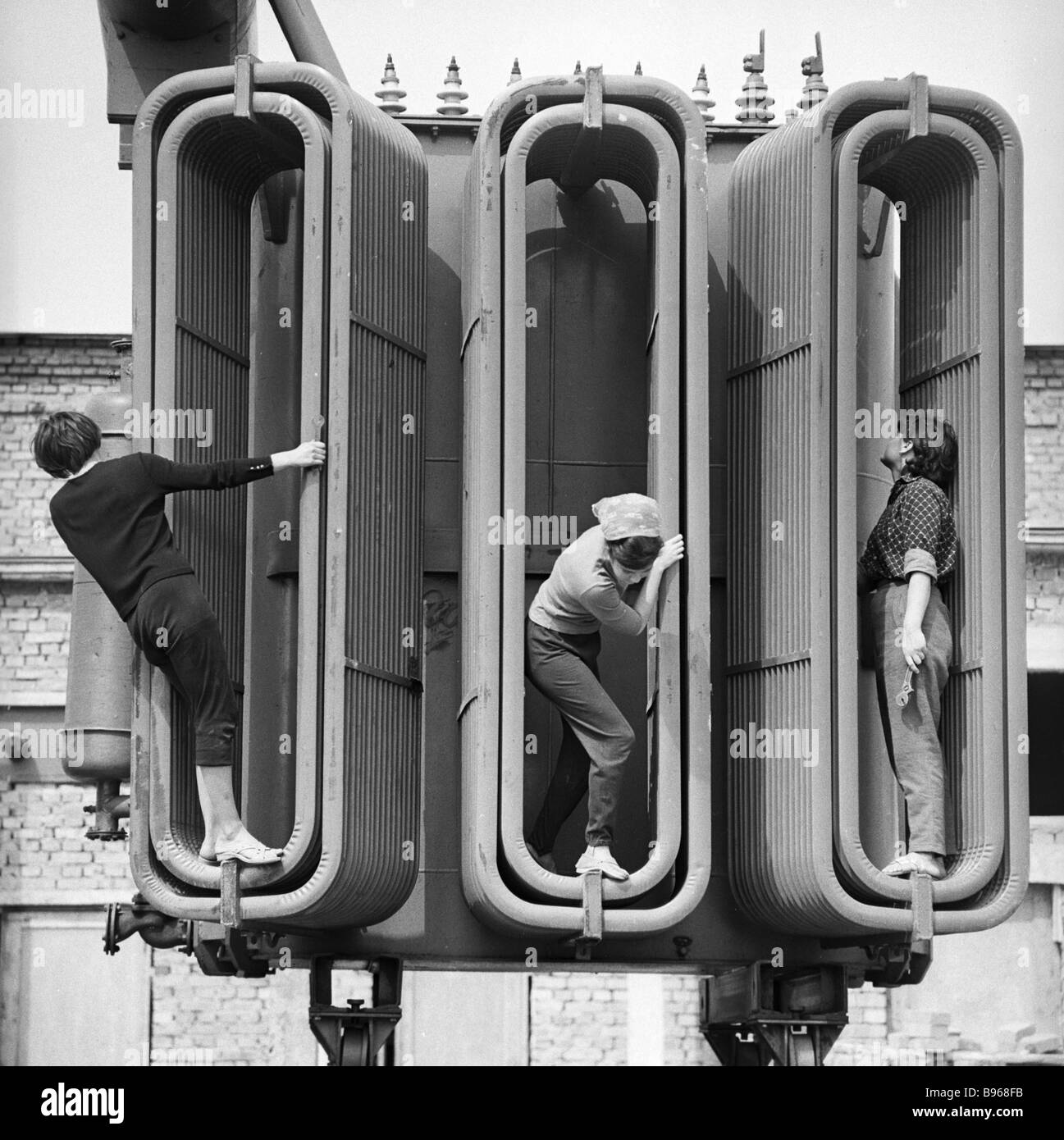 Young workers assemble transformer Stock Photo - Alamy
