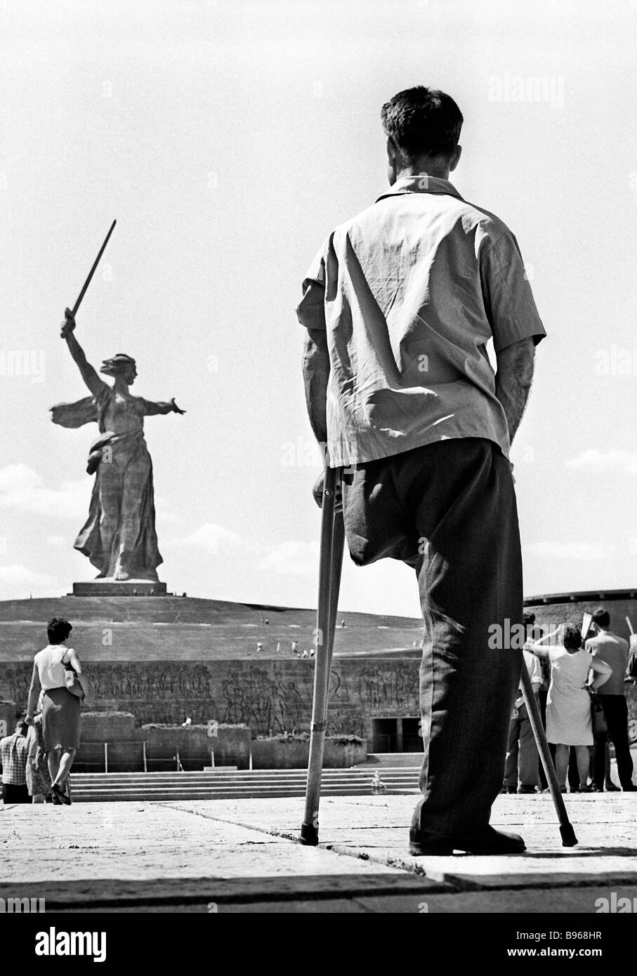 A man on crutches with one leg amputated looking at The Motherland ...