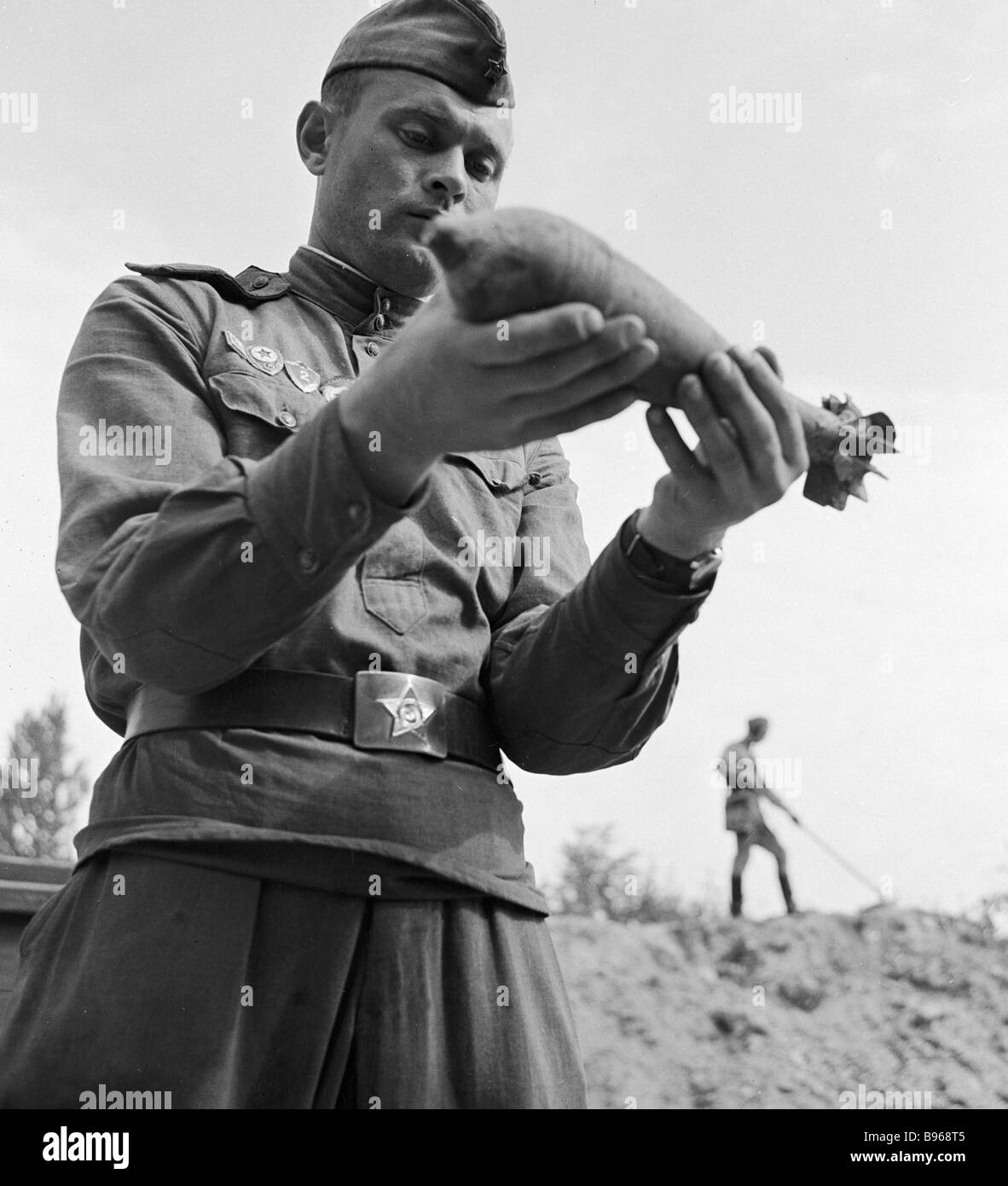 A sapper examining a mine from the munitions depot in the Brest ...