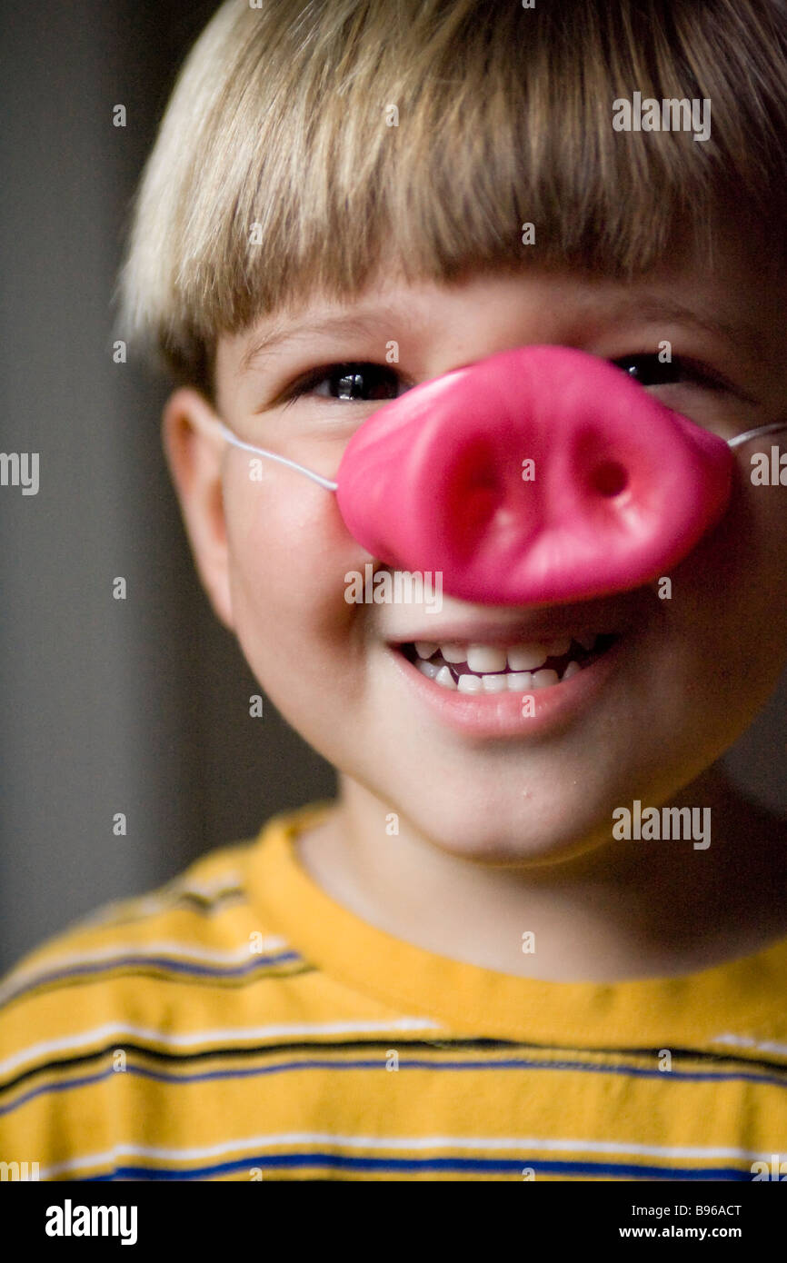 Three year old boy with a fake pig nose while grinning Stock Photo - Alamy
