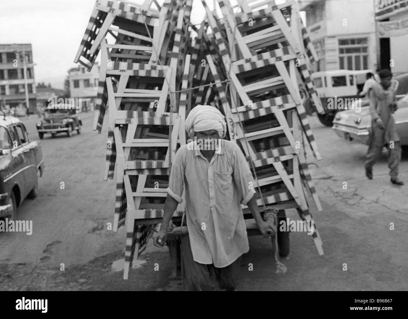 A Karachi resident carting chairs Stock Photo - Alamy