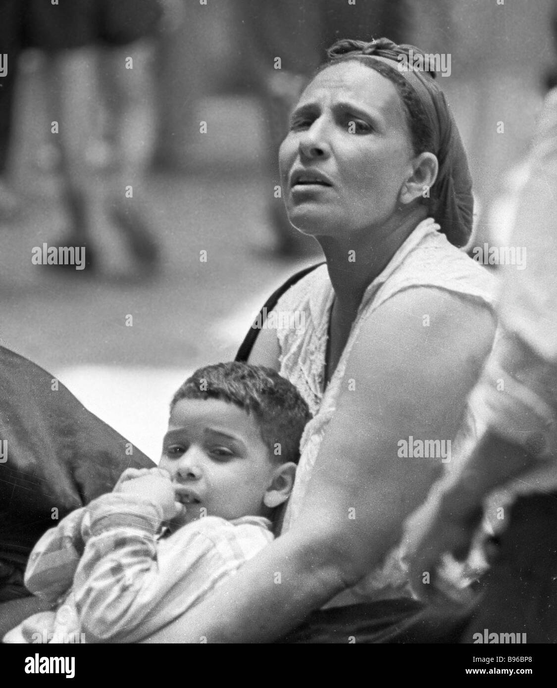 Spanish woman hugs child Stock Photo - Alamy