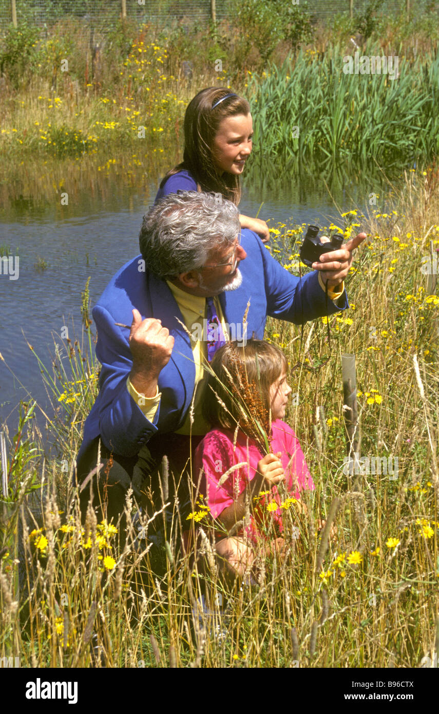 Rolf Harris with children in flower meadow at opening of Wildfowl and ...